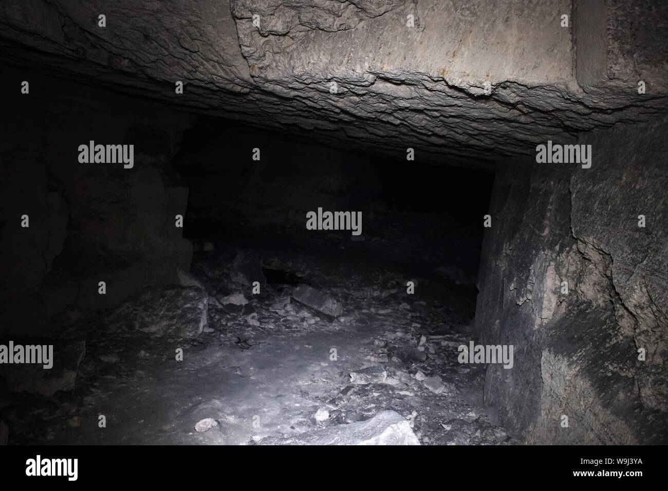 Old underground passage, dungeon, catacombs lined with stones and slabs ...
