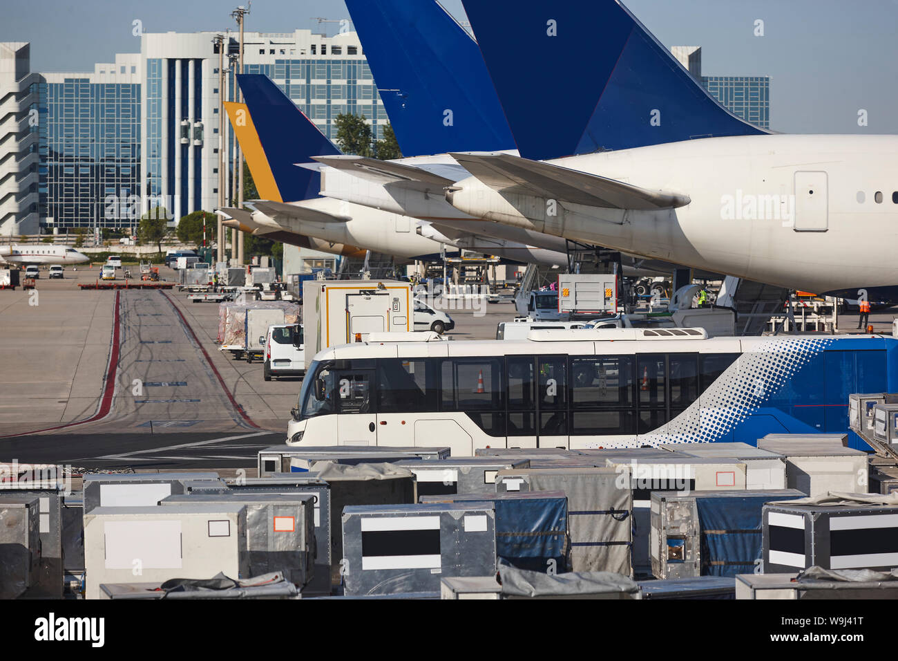 Airport runaway traffic with aeroplanes and cargo vehicles. Busy ...