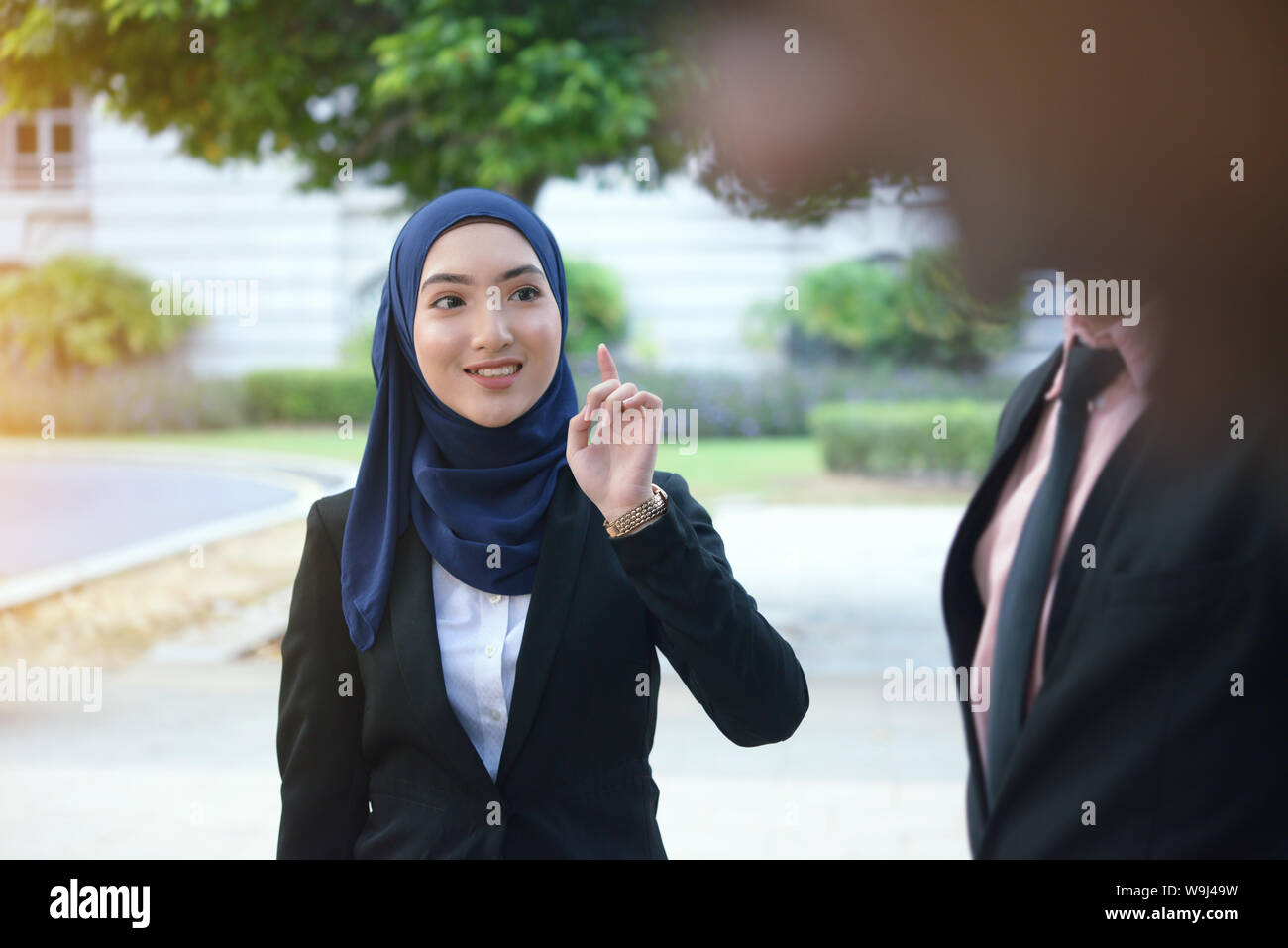 malay muslim business woman having conversation Stock Photo - Alamy
