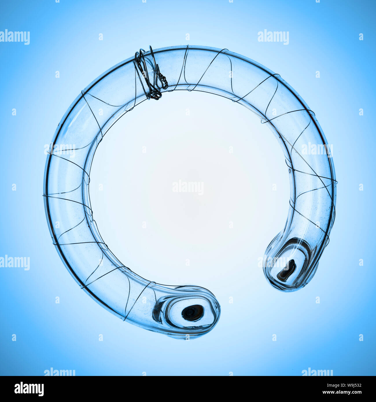 A glass photographic flash tube on a blue background Stock Photo - Alamy