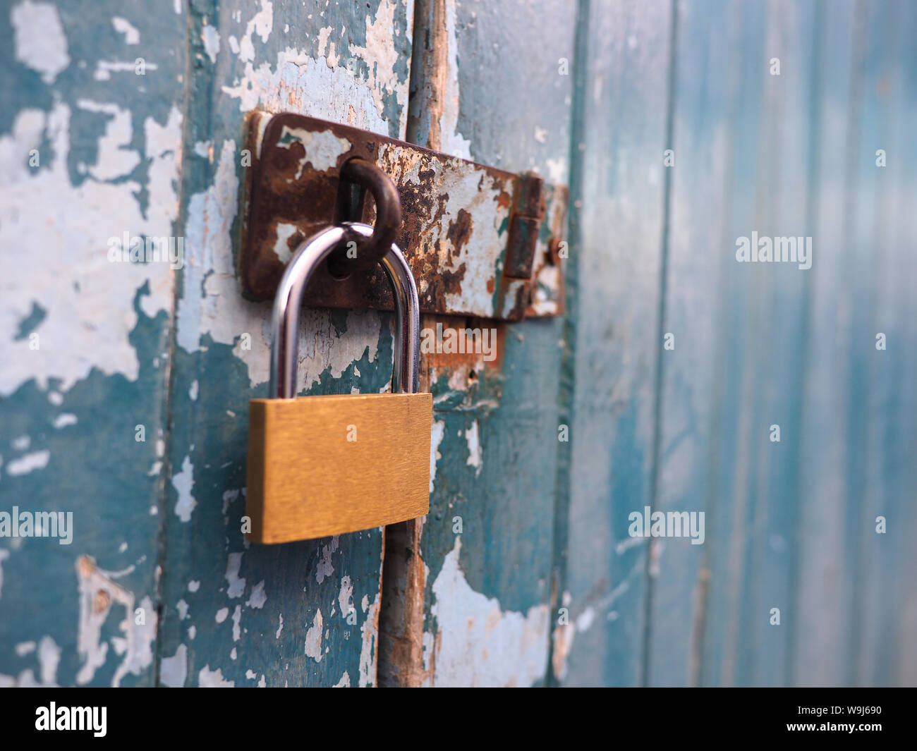 Golden Door Lock in blue wooden door Stock Photo - Alamy