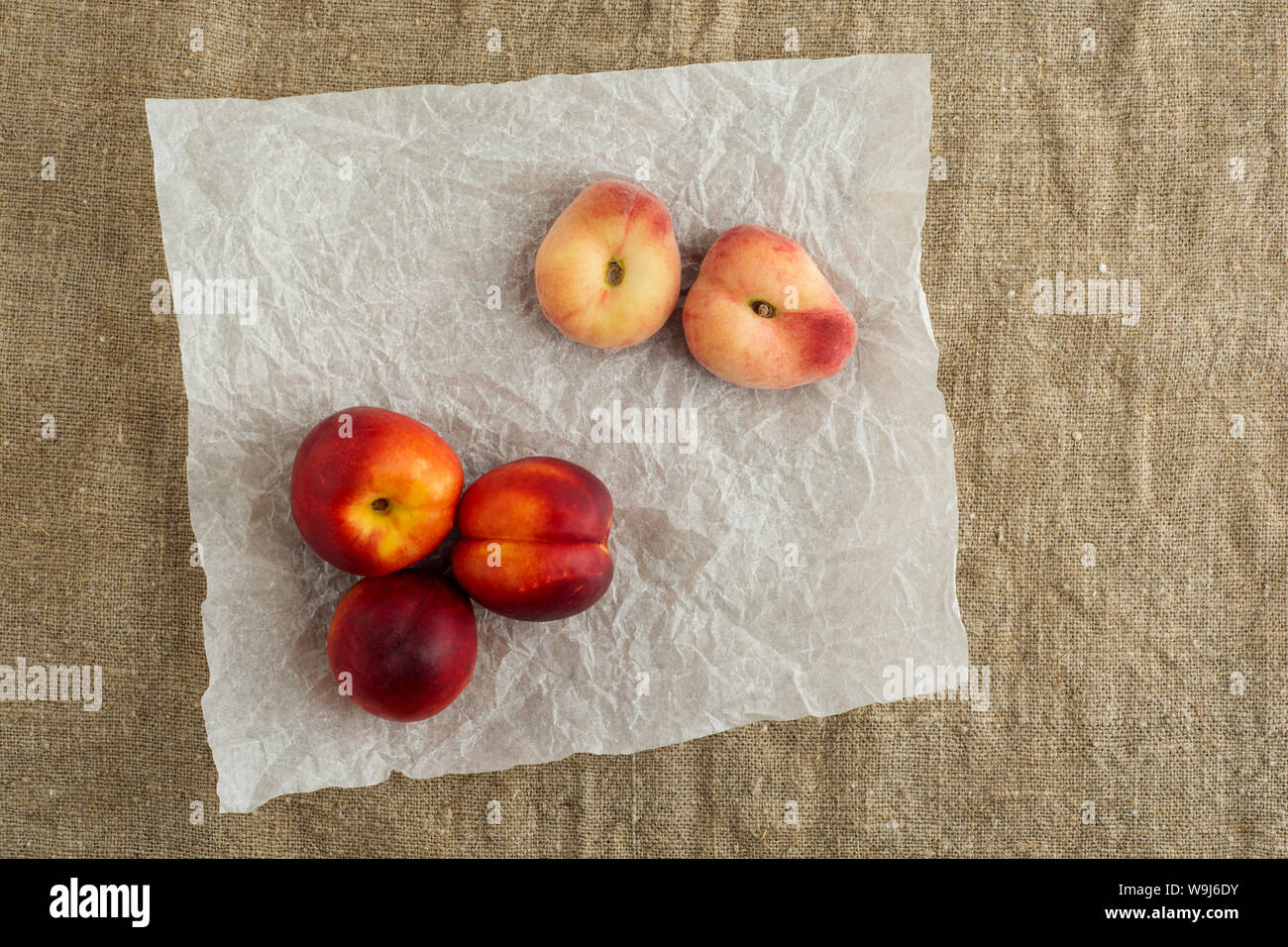 Donut Peaches also known as Saturn peaches and nectarine on a rustic ...