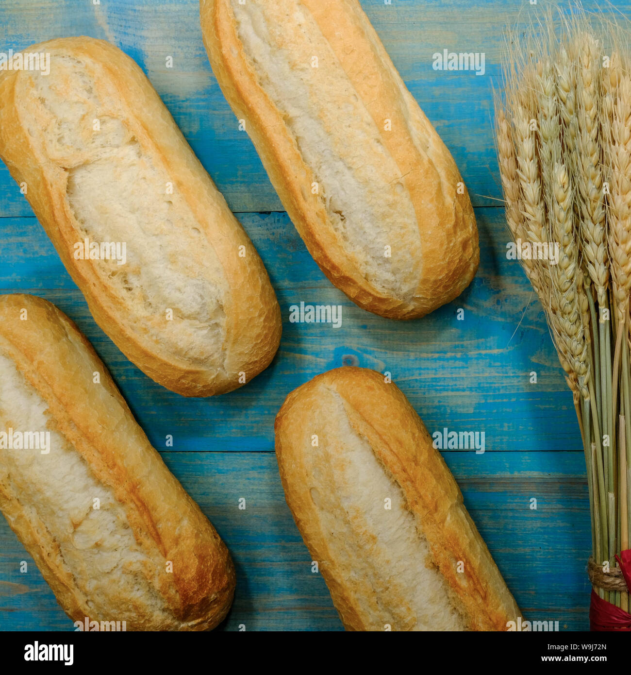 Crusty Fresh White Bread Rolls With a Bunch of Dried Wheat Stock Photo ...