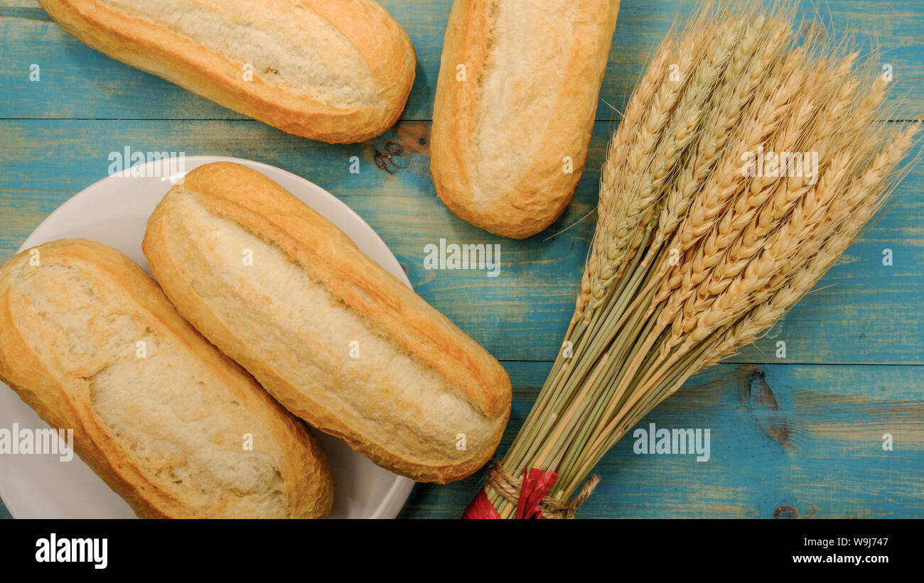 Crusty Fresh White Bread Rolls With a Bunch of Dried Wheat Stock Photo ...