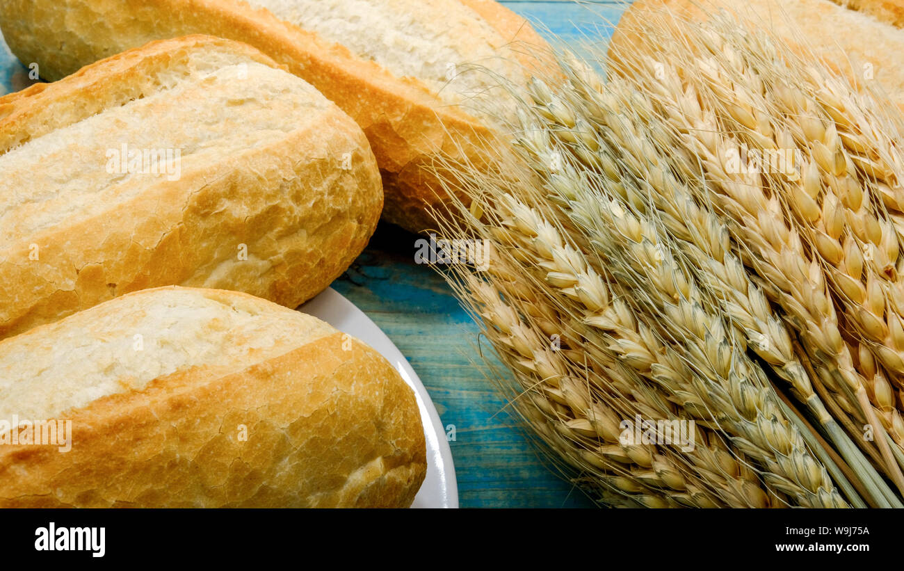 Crusty Fresh White Bread Rolls With a Bunch of Dried Wheat Stock Photo ...