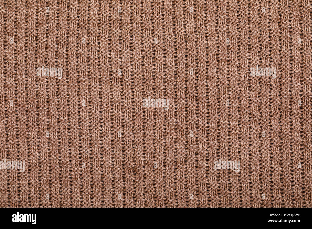 Real brown knitted fabric with ornamental pattern textured background ...
