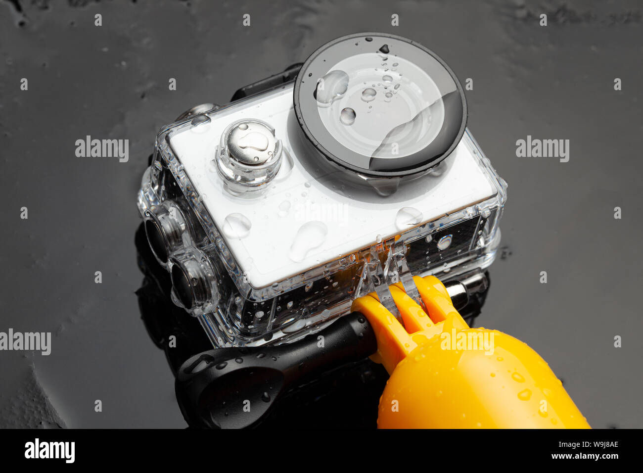 Action camera in a waterproof box and a buoy for diving in water drops ...
