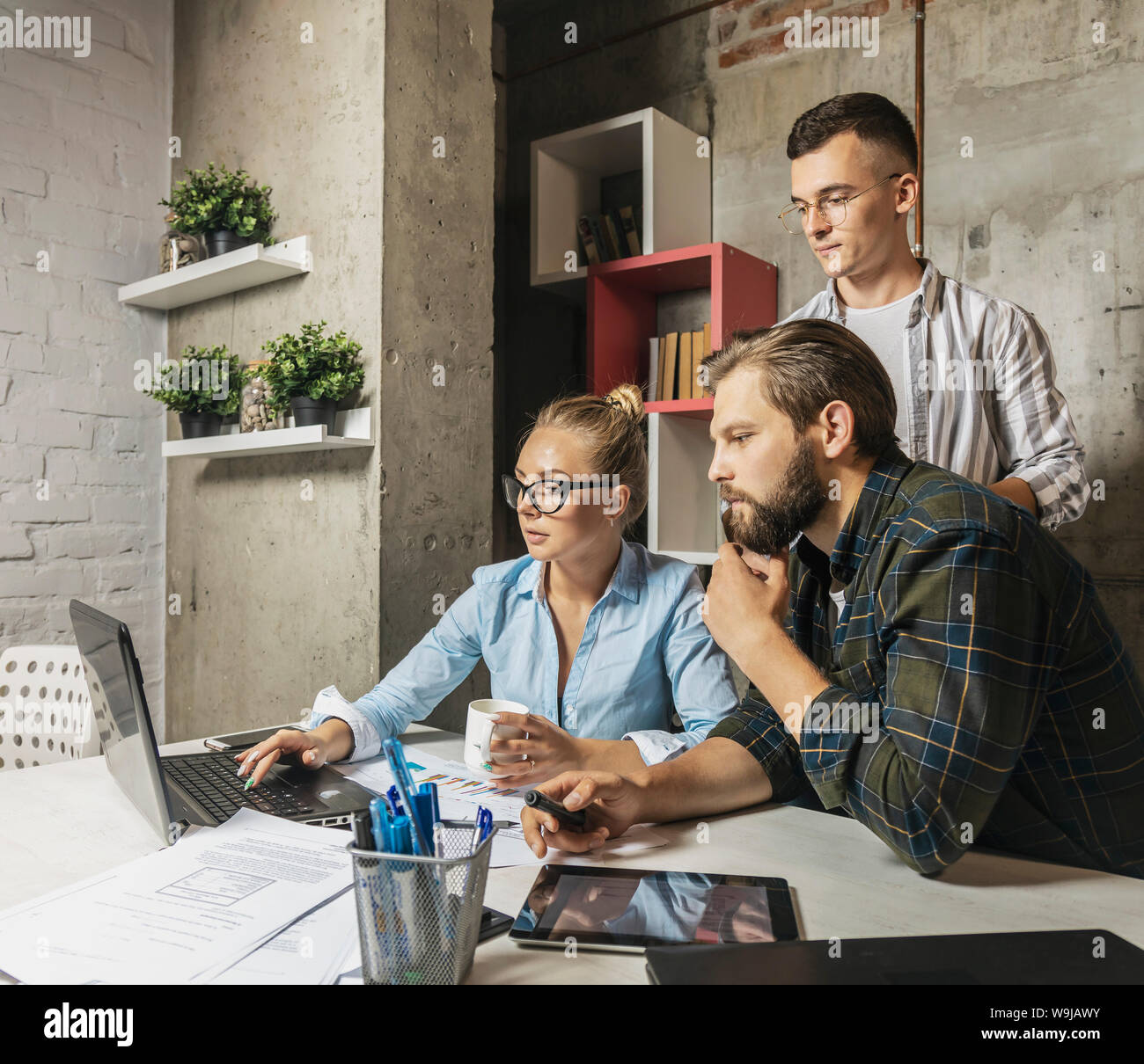Young clerks planning their work in team Stock Photo - Alamy