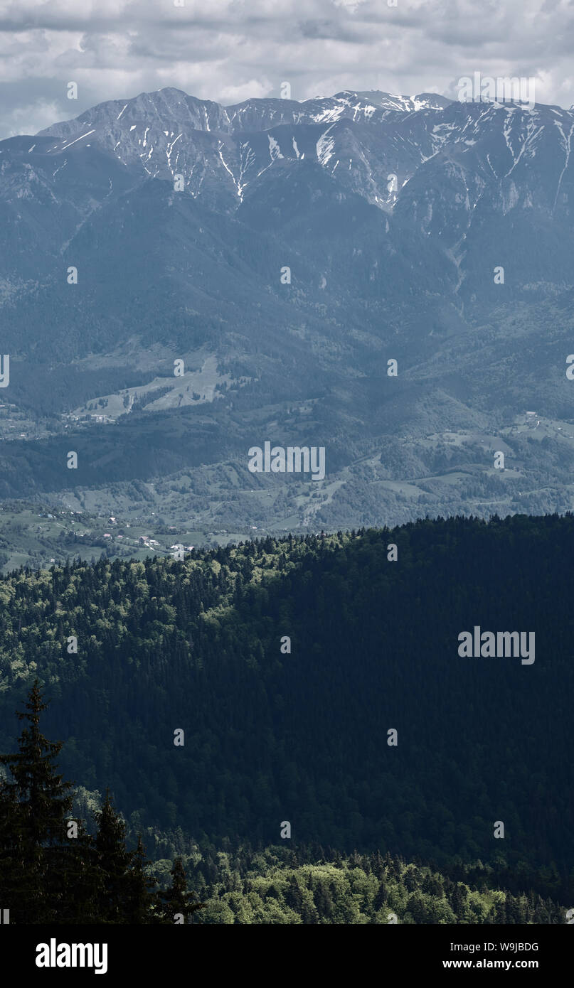 Mountain landscape with an afforested valley Stock Photo - Alamy