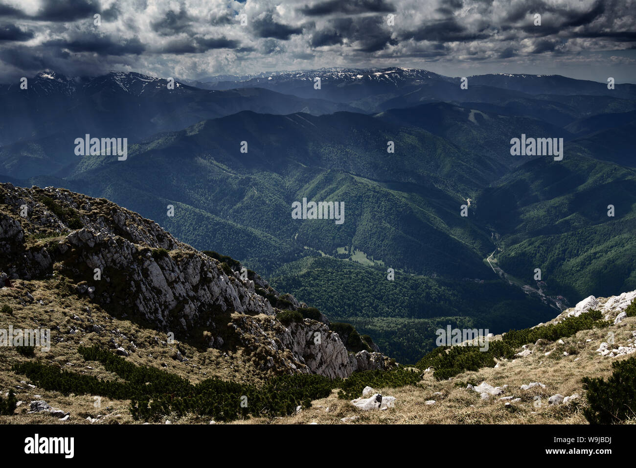 Mountain landscape with an afforested valley Stock Photo - Alamy
