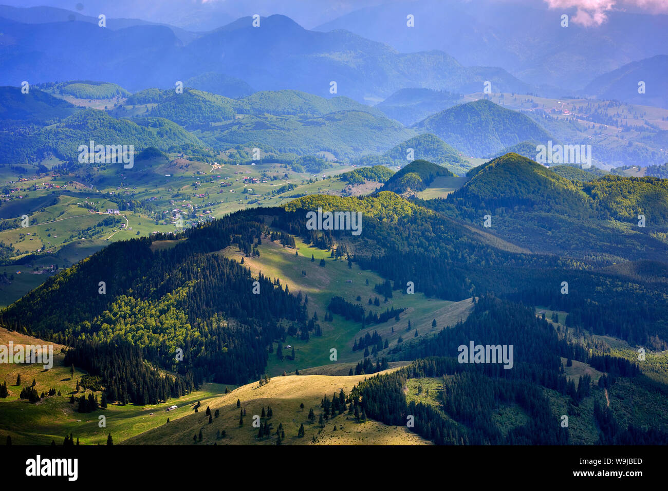 Mountain landscape with an afforested valley Stock Photo - Alamy