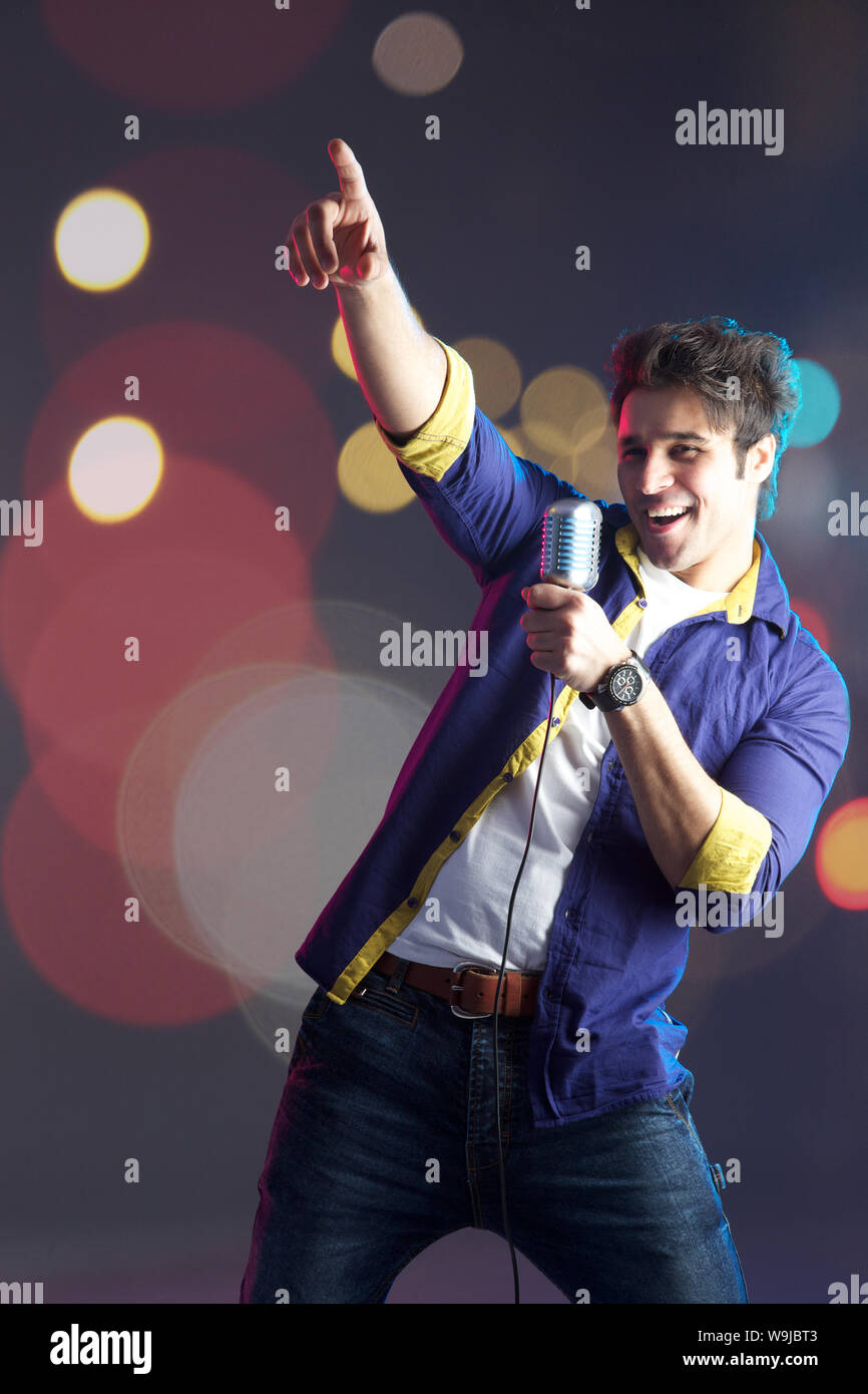 Man singing into microphone and dancing Stock Photo - Alamy