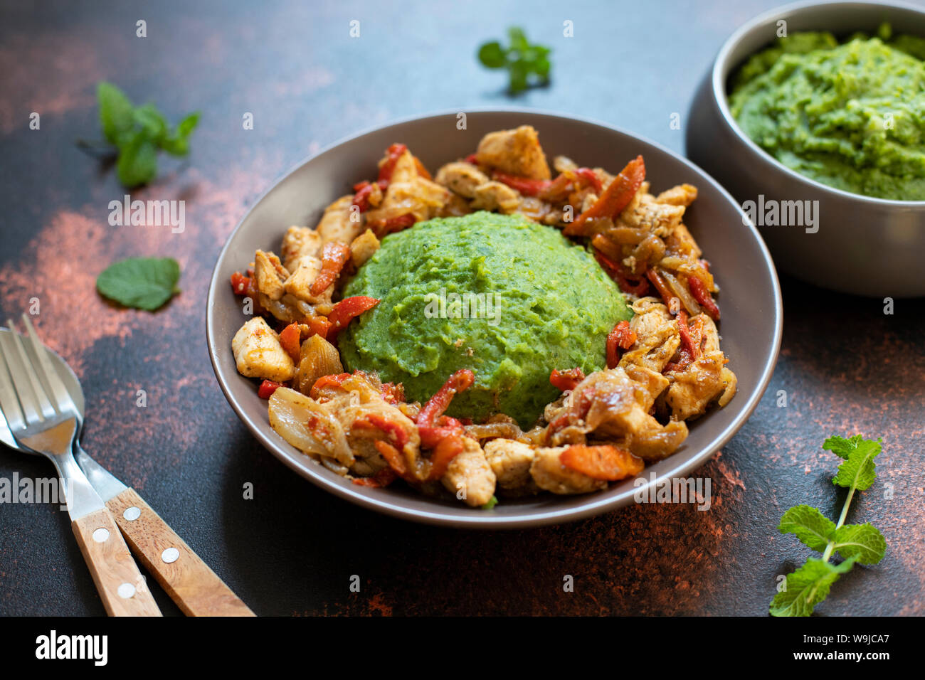 Mashed potatoes with green peas and corn served with chicken and ...
