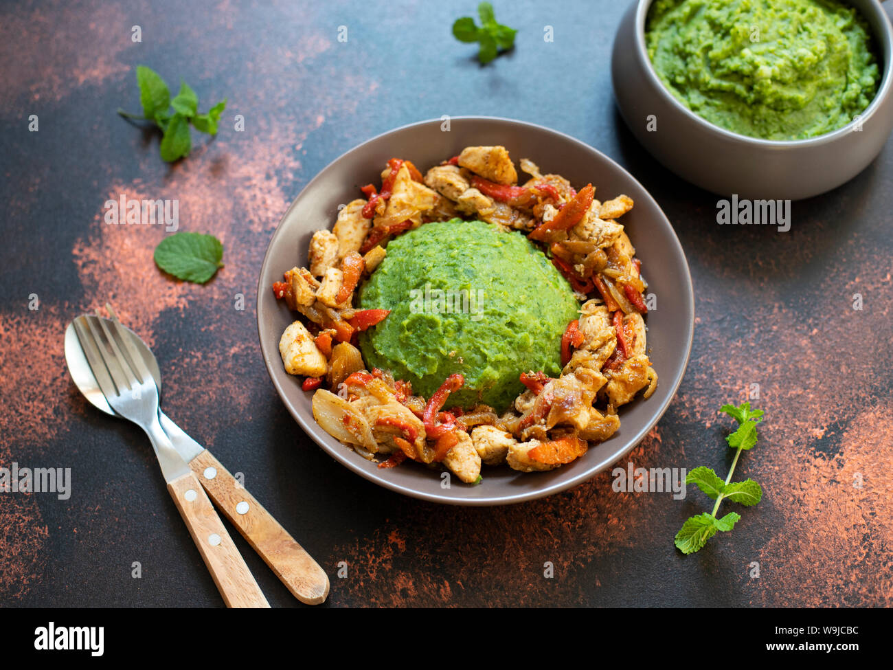 Mashed potatoes with green peas and corn served with chicken and ...