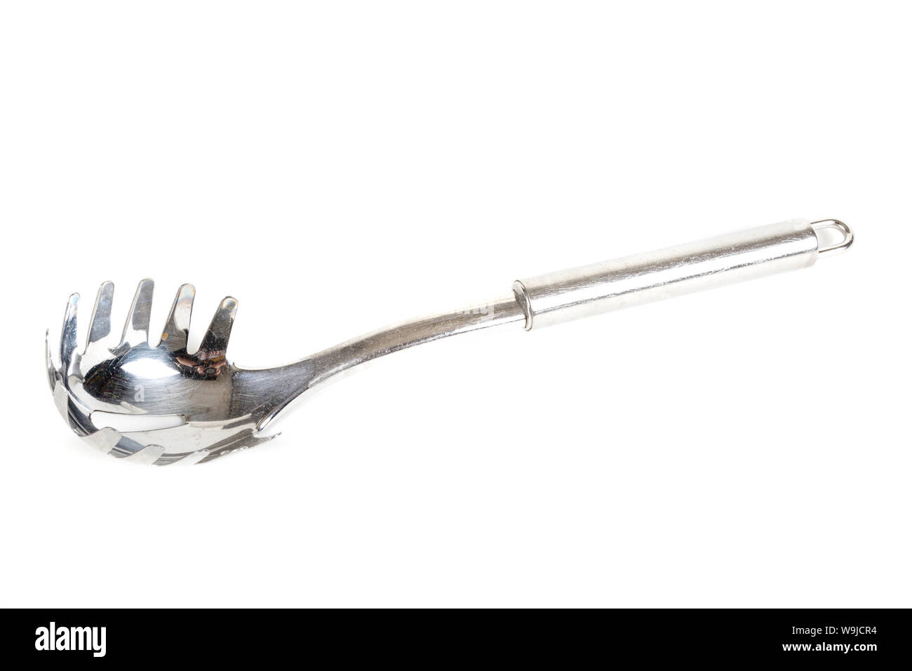 A metal pasta server isolated on a white background Stock Photo - Alamy