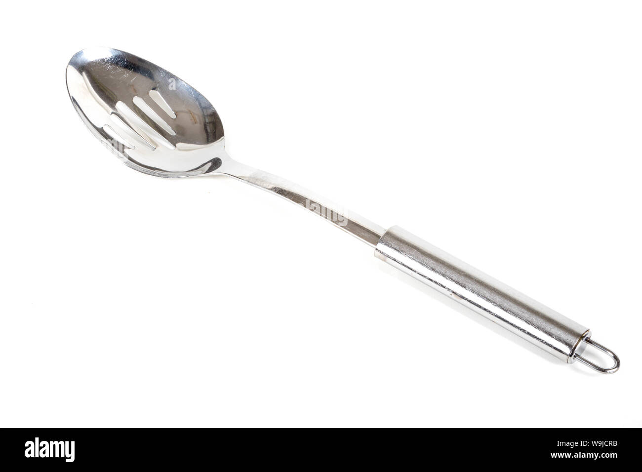 A metal draining spoon isolated on a white background Stock Photo - Alamy
