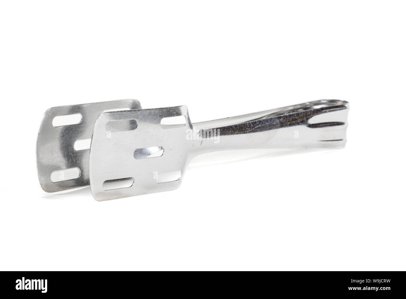 A metal pair of tongs isolated on a white background Stock Photo - Alamy