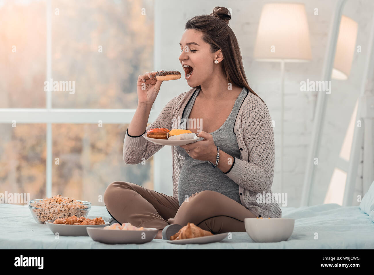 Biting food female full length hi-res stock photography and images - Alamy
