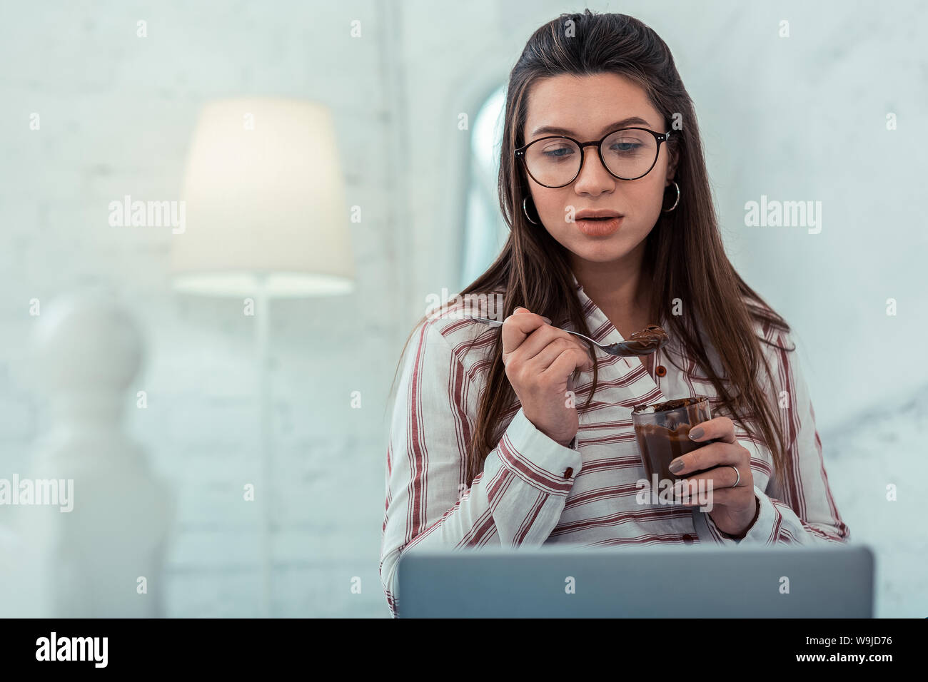 Amazing longhaired woman staring at screen of laptop Stock Photo - Alamy