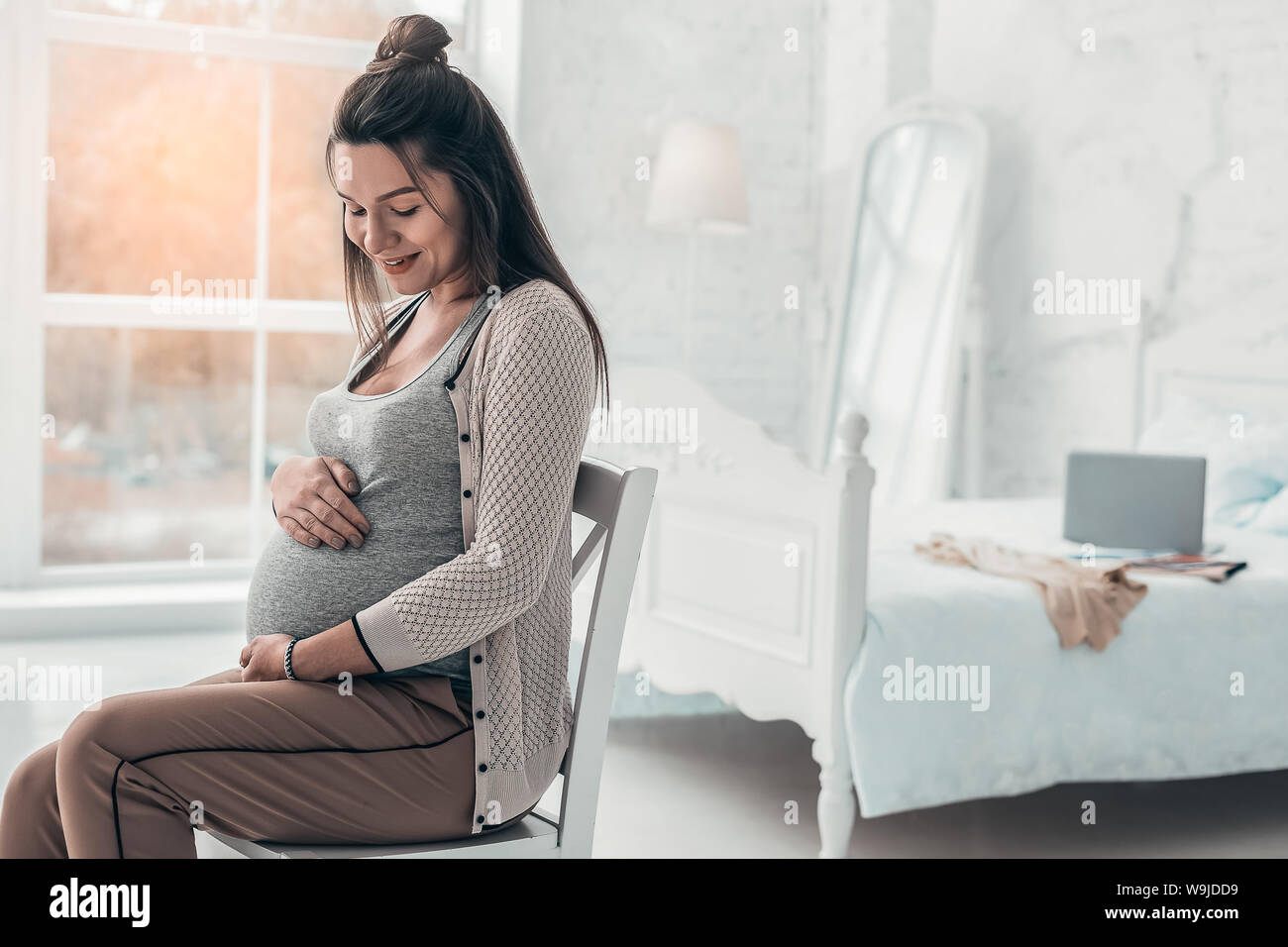 Positive delighted future mommy expecting her baby Stock Photo - Alamy