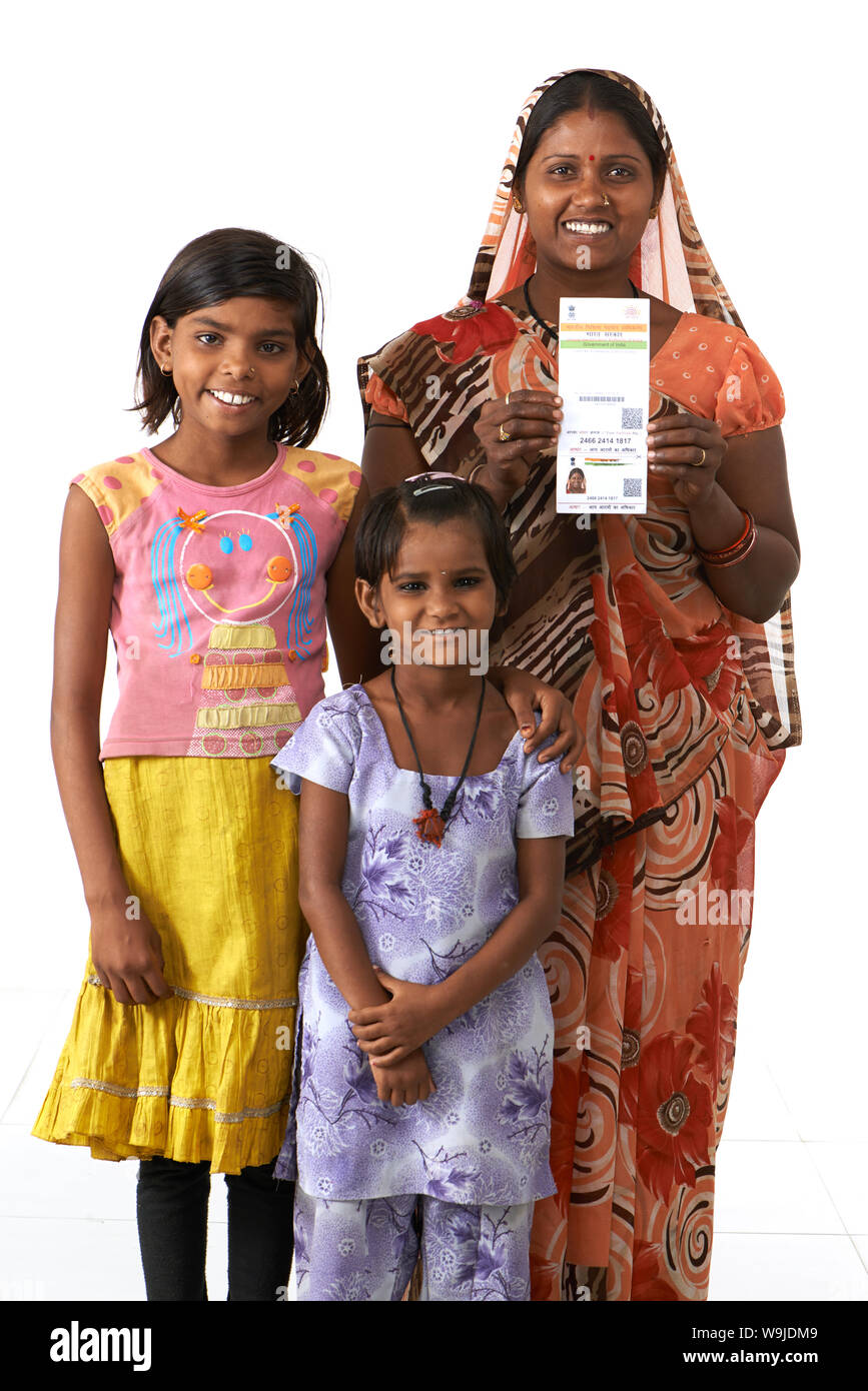 Rural woman showing an Aadhar card with her daughters Stock Photo - Alamy
