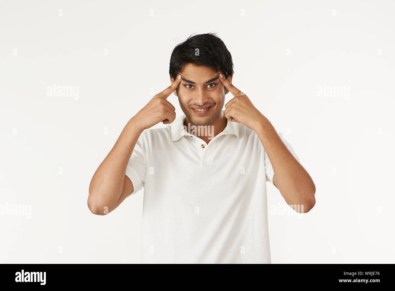 Young man touching his forehead and making a face Stock Photo - Alamy