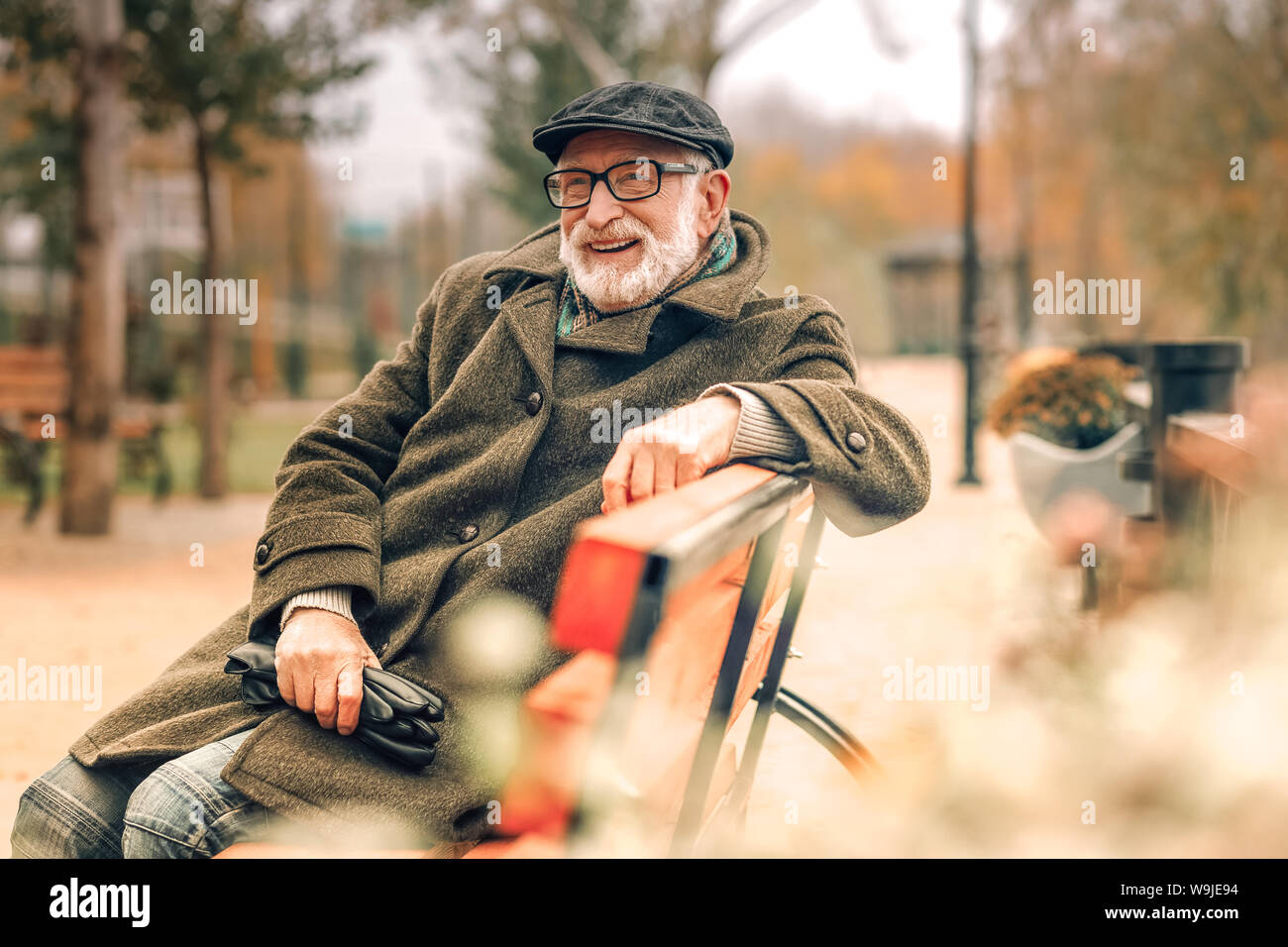 One senior man sitting on white bench hi-res stock photography and ...