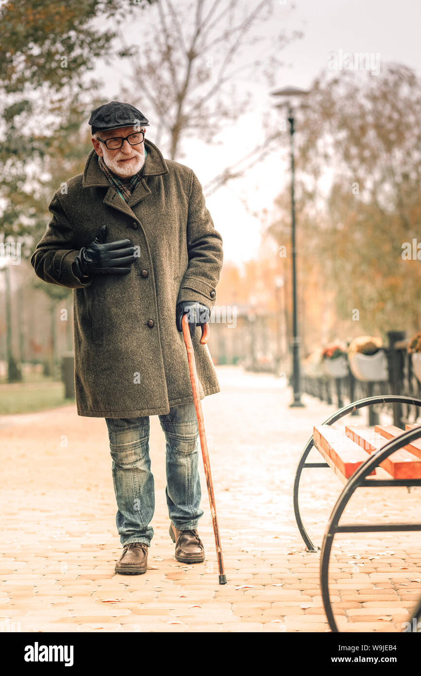 Old man walking alone in a park hi-res stock photography and images - Alamy