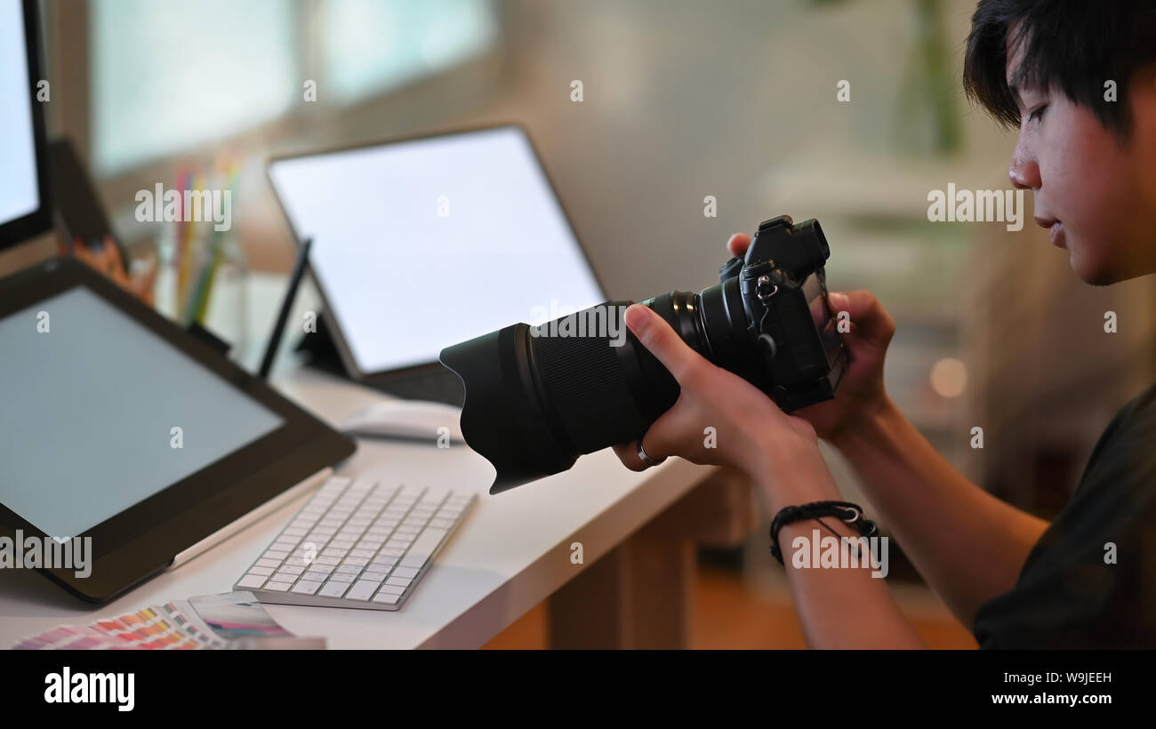 Shot of photographer working with professional camera in creative ...