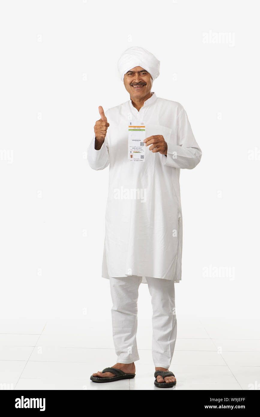 Rural man showing an Aadhar card with thumbs up sign Stock Photo - Alamy