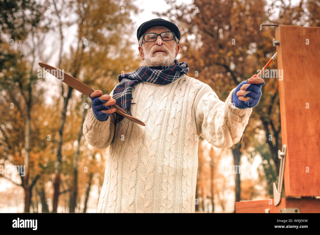 Low angle of an artist painting in park Stock Photo - Alamy
