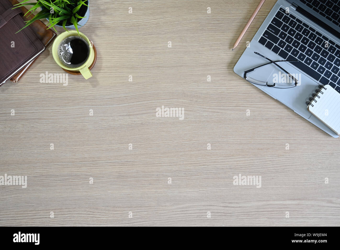 Office desk top view wood table with laptop, glasses, coffee and office ...