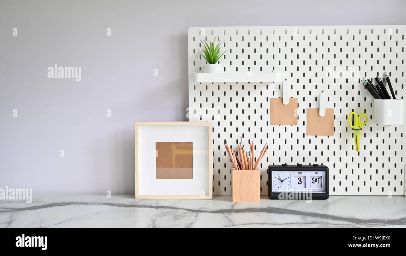 Front view of marble desk and office supply with pegboard Stock Photo ...