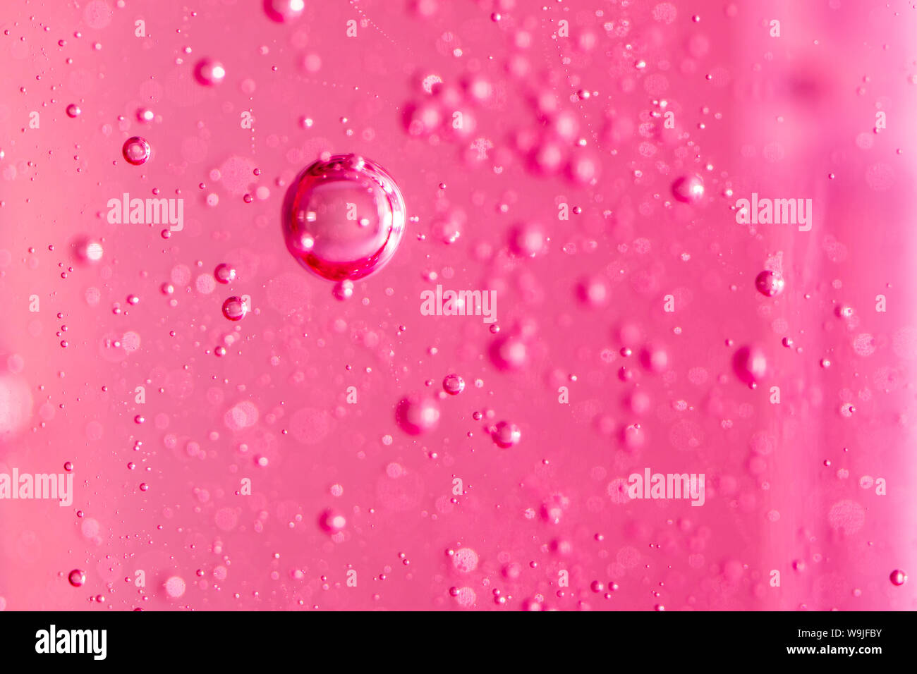 Macro Oxygen bubbles in water on a pink background, concept such as ...