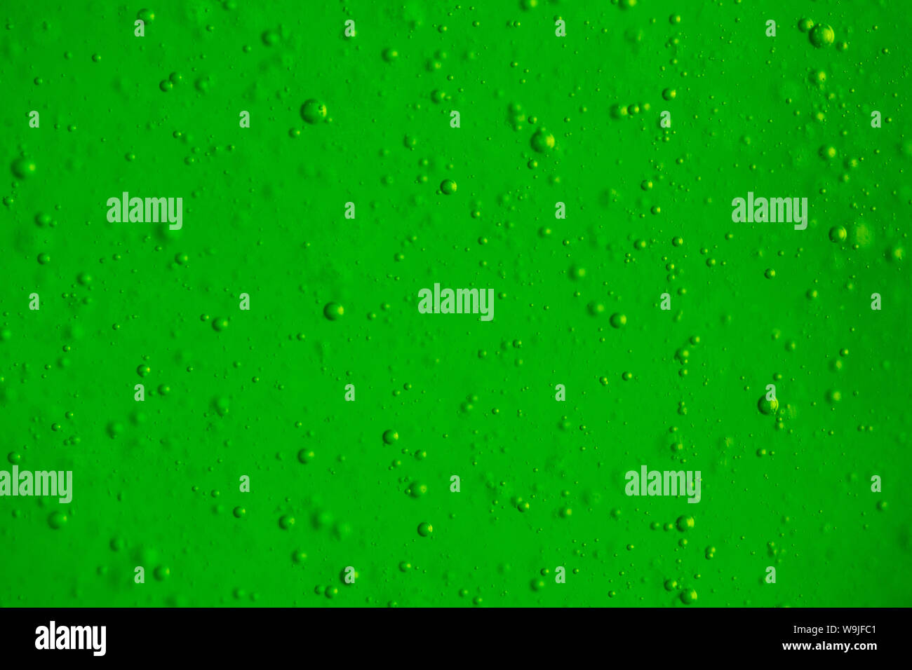 Macro Oxygen bubbles in water on a green background, concept such as ...