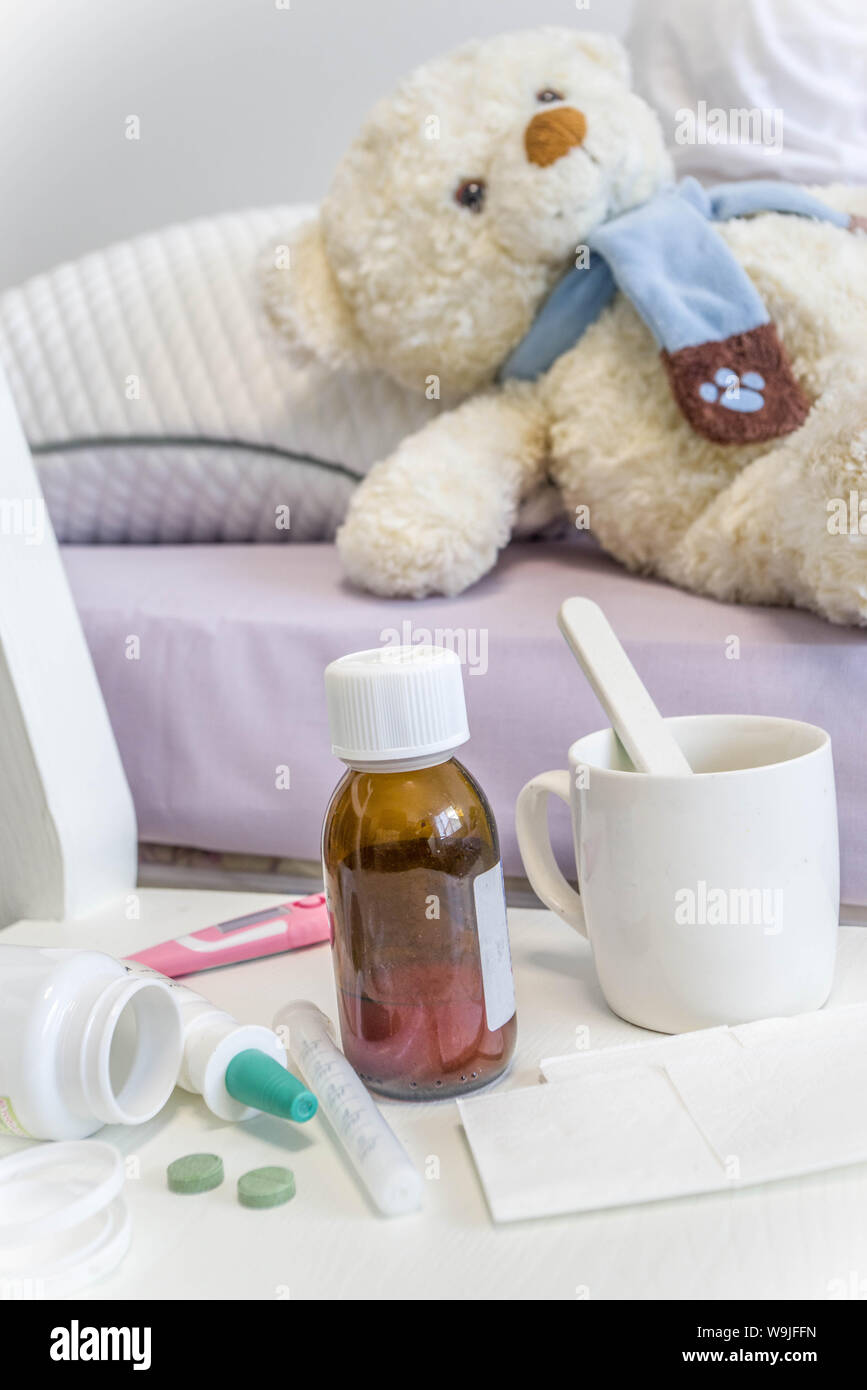 Seasonal flu concept, ill kid girl with with pills, medicines ...