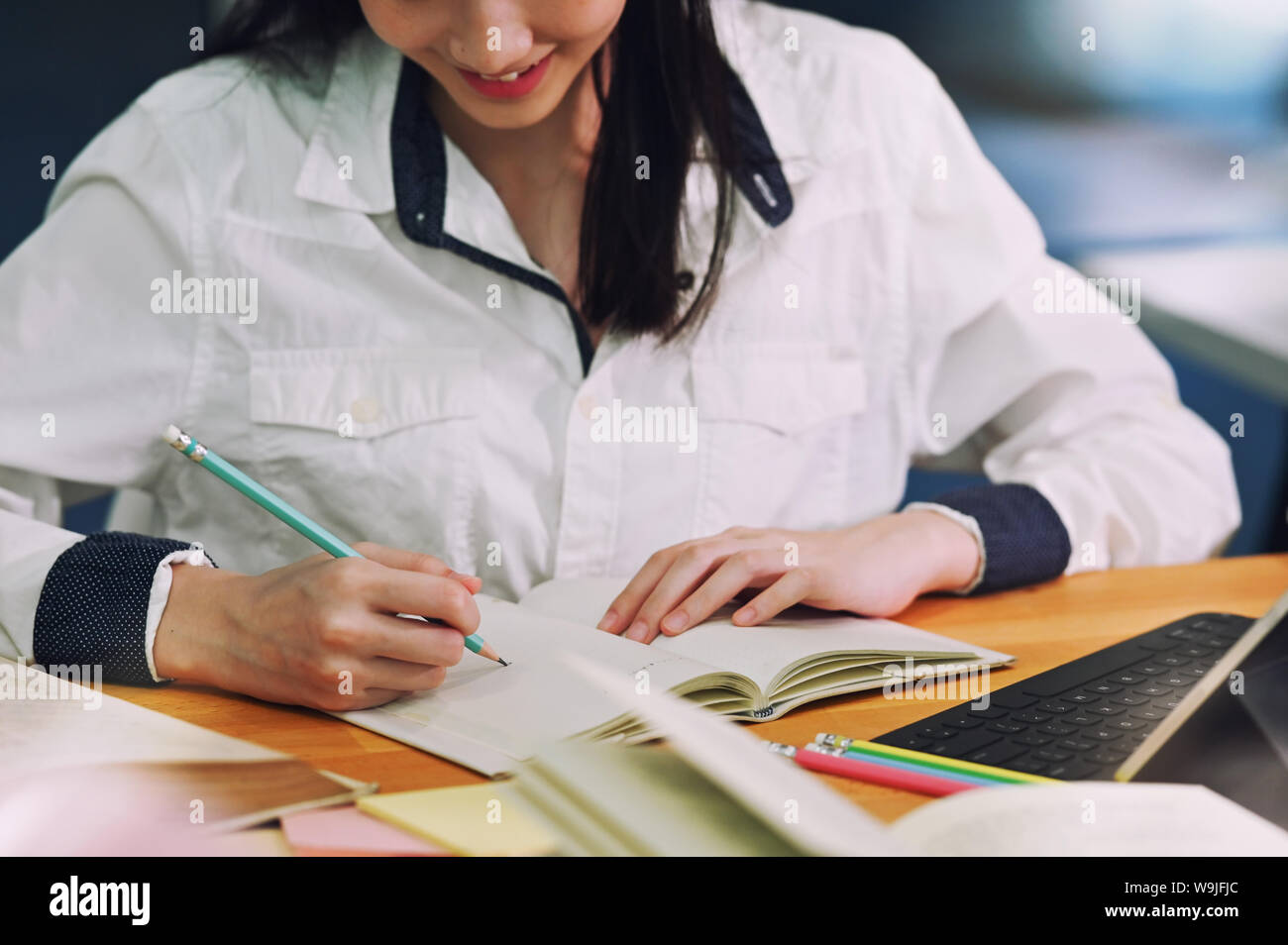 Collage student studying her exam in school library Stock Photo - Alamy
