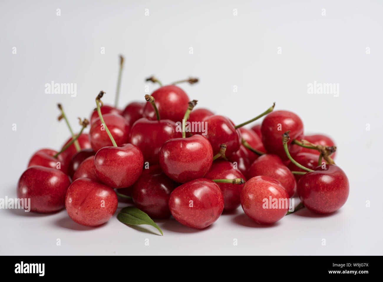Bunch of fresh cherries on white background Stock Photo - Alamy