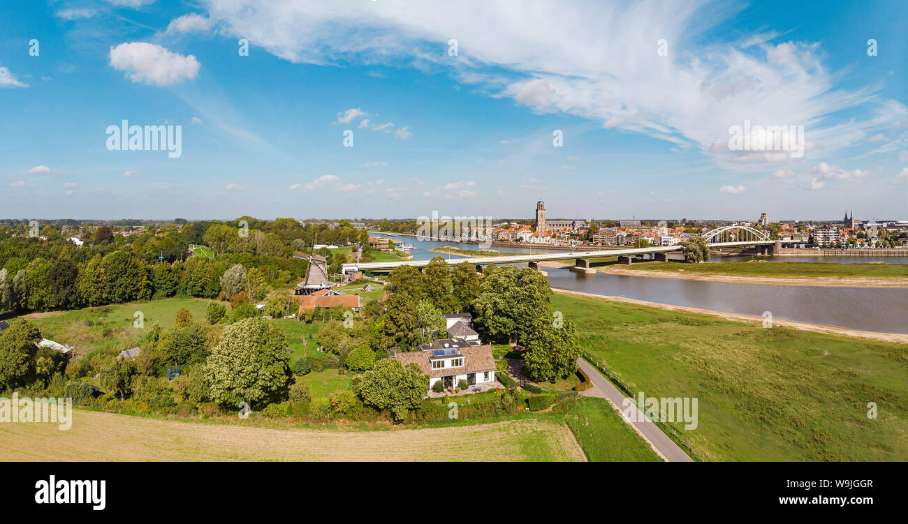 The windmill, bridge over the river IJssel and the Lebuinus church ...