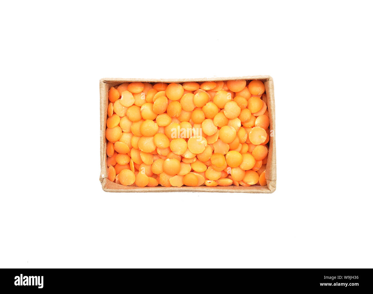 Red lentils in carton and white background Stock Photo - Alamy