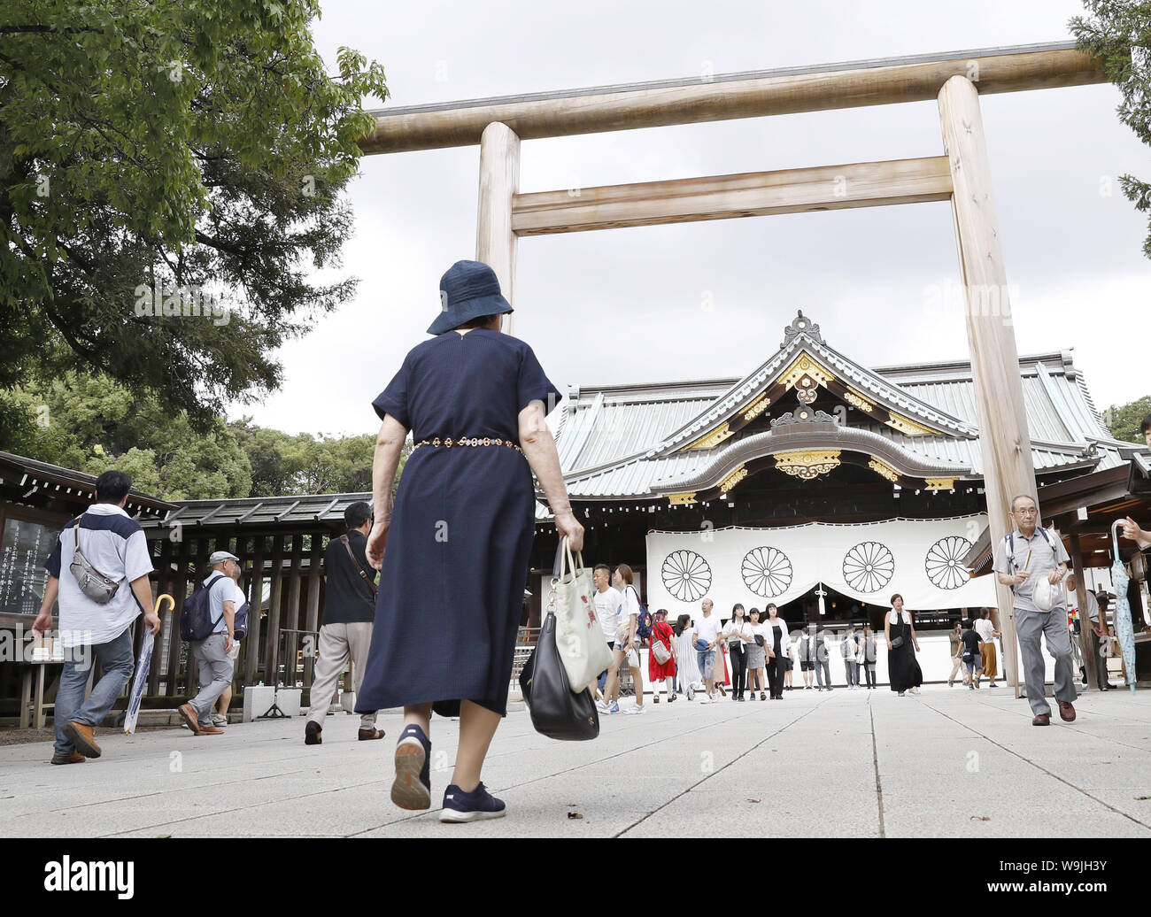 People visit Tokyo's war-linked Yasukuni Shrine on Aug. 14, 2019, a day ...