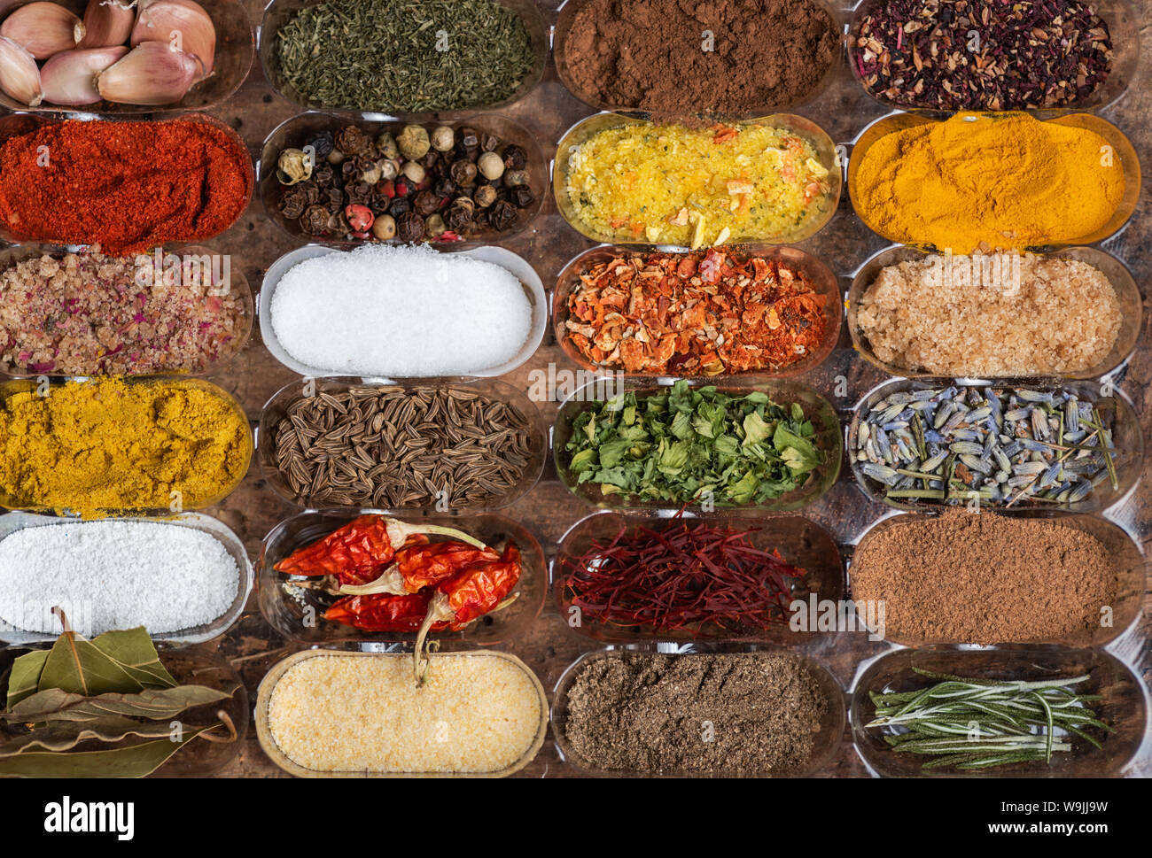 Multiple different spices in small containers Stock Photo - Alamy