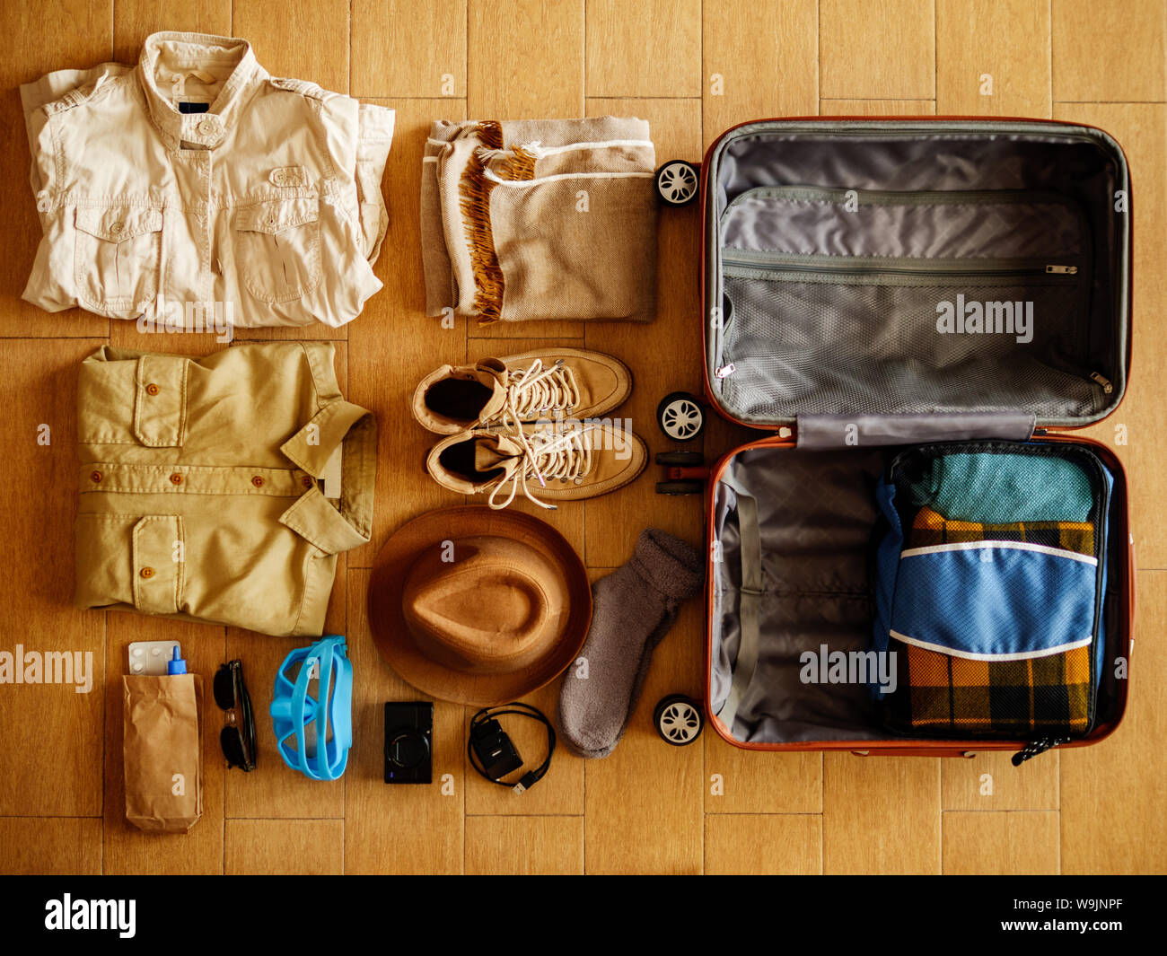 Open suitcase packed for travelling Stock Photo - Alamy