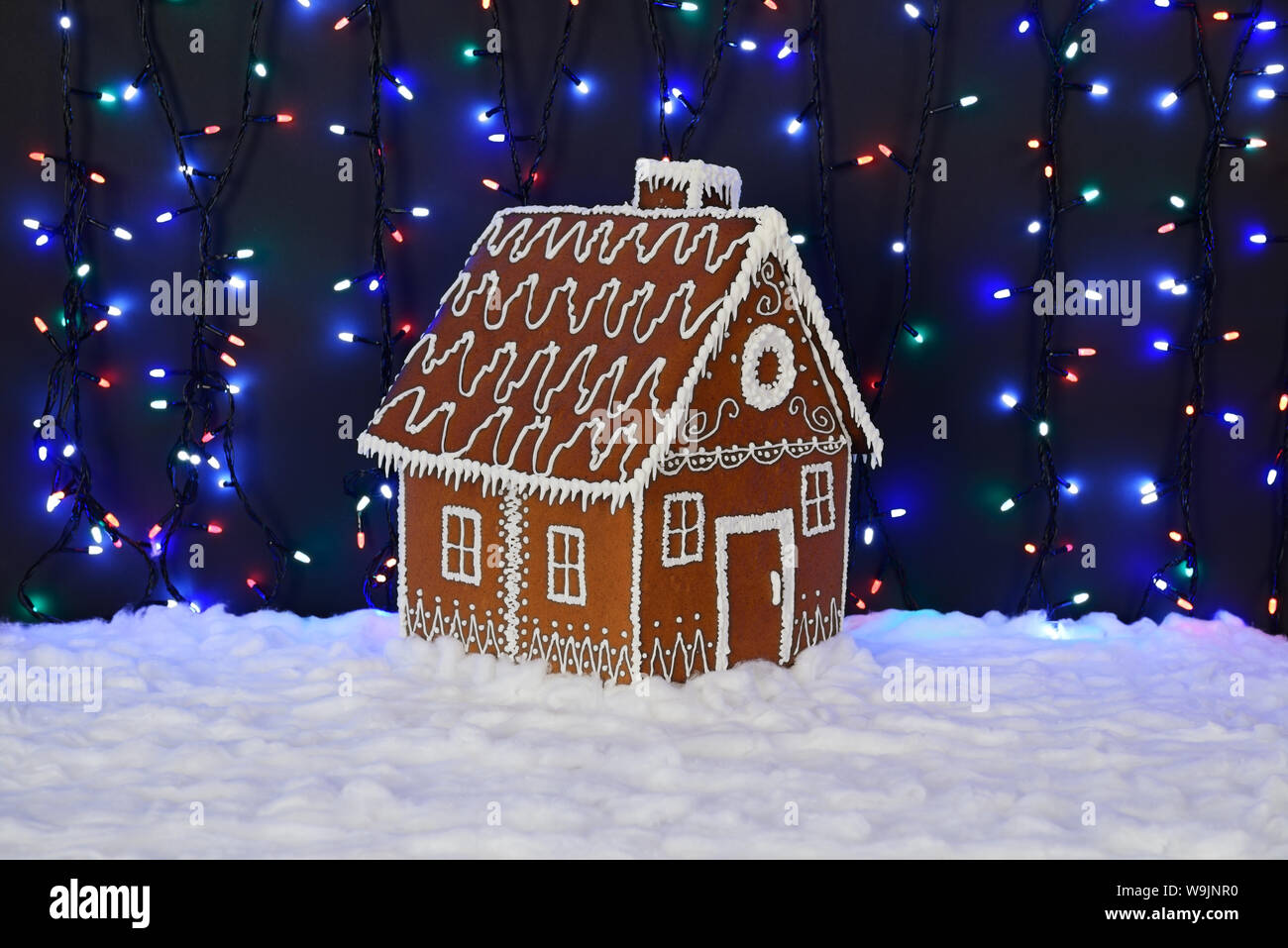 The hand-made eatable gingerbread house, snow decoration, garland ...