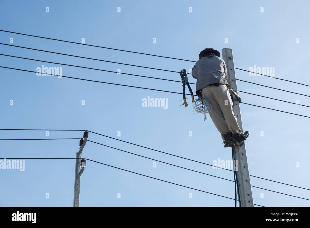 Electricty Power Lines Man Climbing. Repair Man Repair Electrical ...