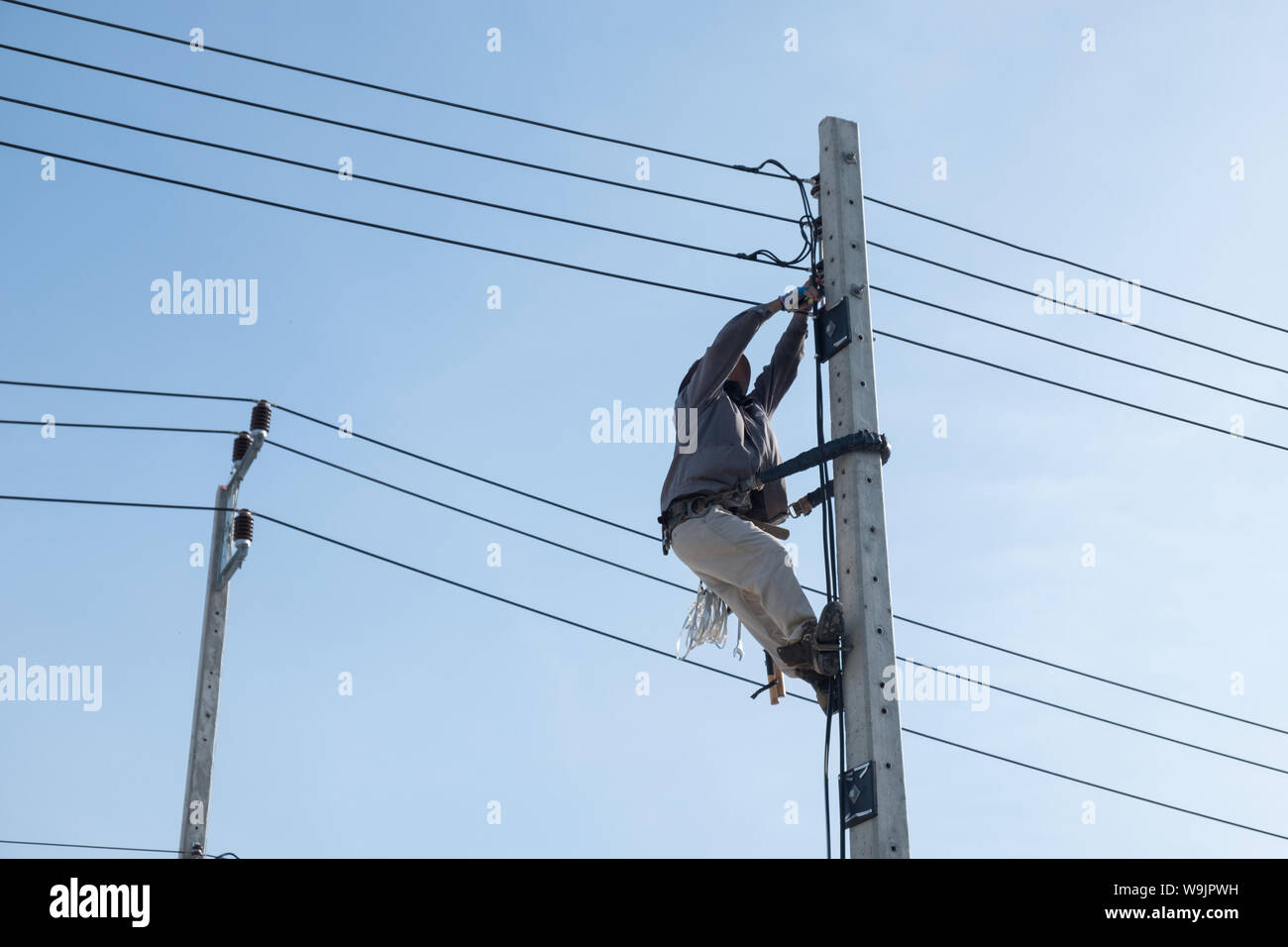 Electricty Power Lines Man Climbing. Repair Man Repair Electrical ...
