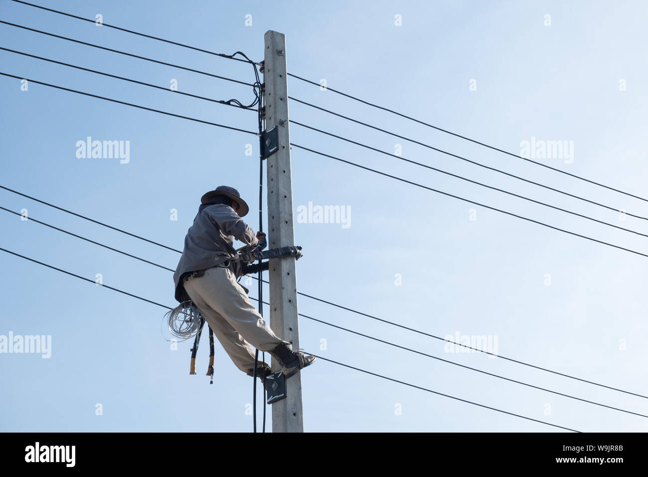 Electricty Power Lines Man Climbing. Repair Man Repair Electrical ...