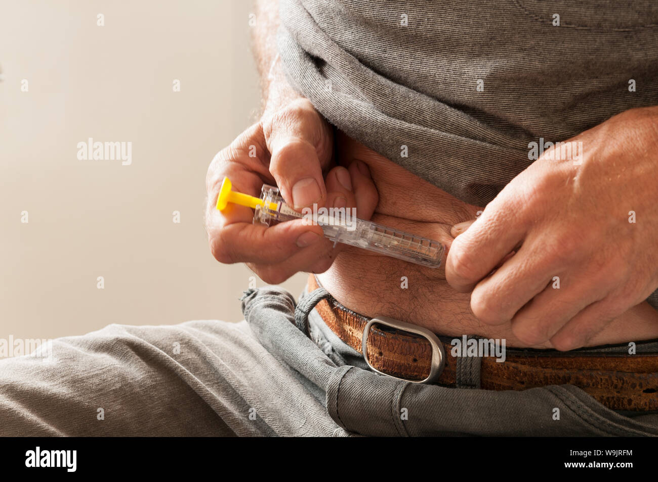 Self injection of Mircera into male stomach, tummy, abdomen in a ...