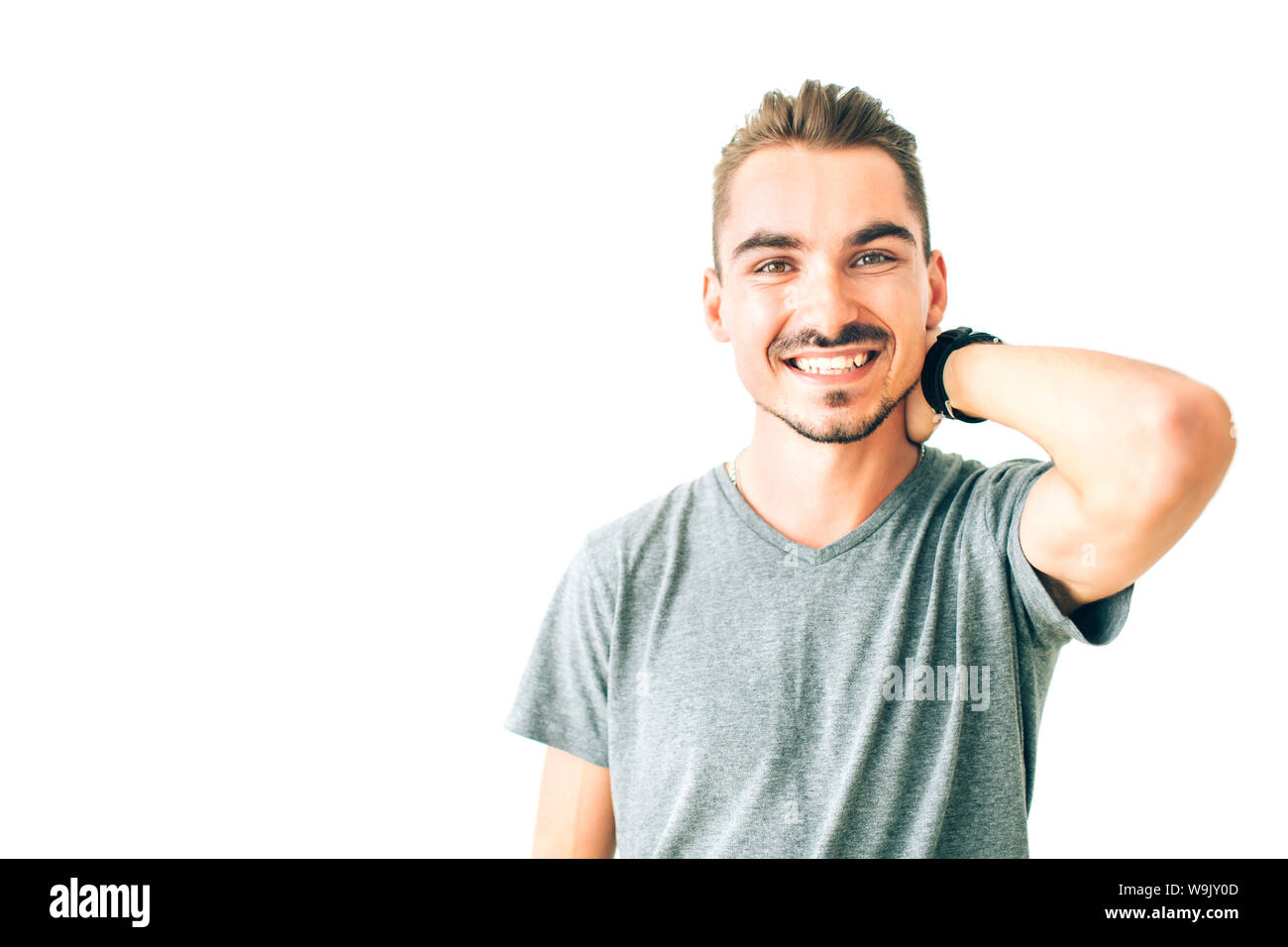 Happy young man smiling, holding one hand over his head on white ...
