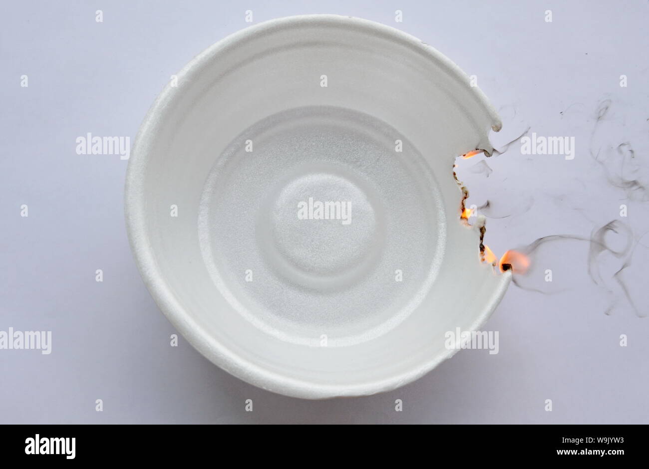 foam bowl burning on white background Stock Photo - Alamy